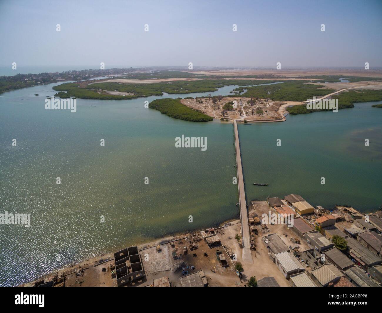 High shot of the sea with a bridge on it surrounded by islands greenery ...