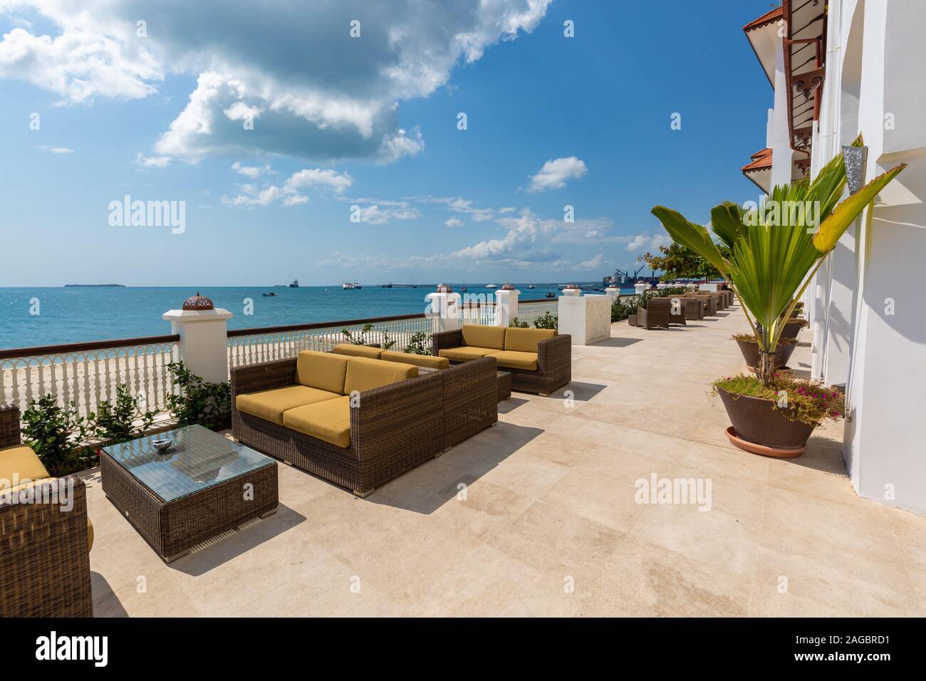 Picture of a luxury hotel roof with decor trees and sea surrounding it ...