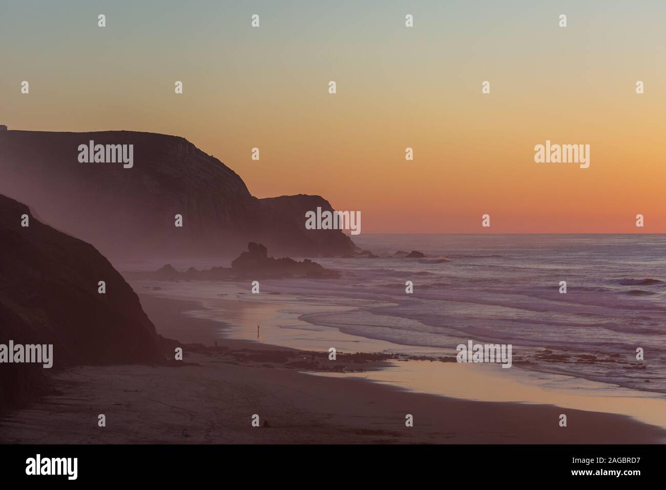 Beautiful picture of the sea covered in fog surrounded by rocks during ...