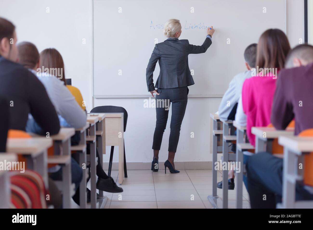 Female professor explain to students and interact with them in the ...