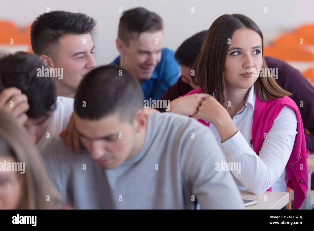 Students sitting in a lecture hall at university while studying and ...
