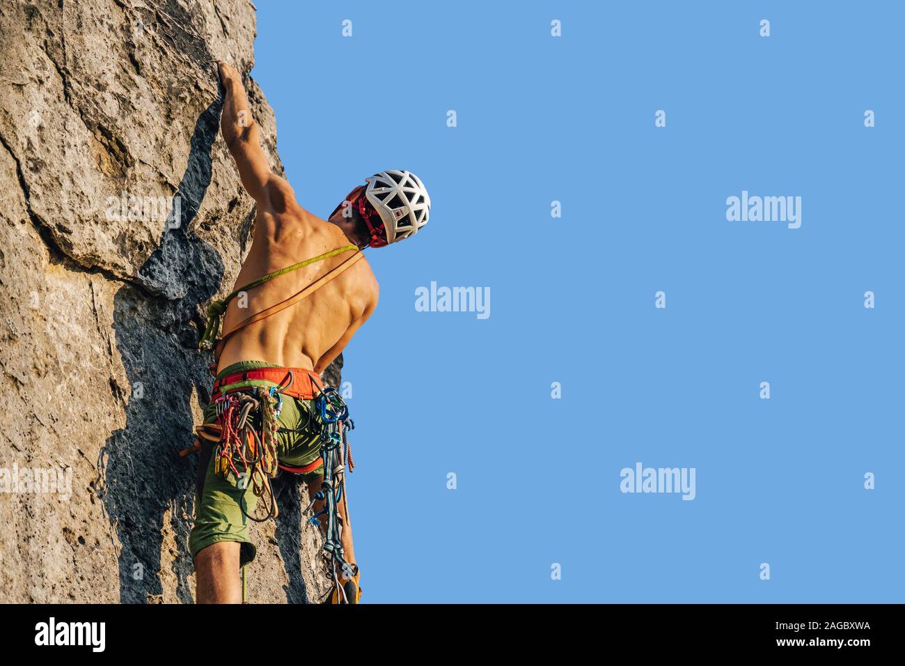 Male mountain climber climbing the mountains with his climbing ...
