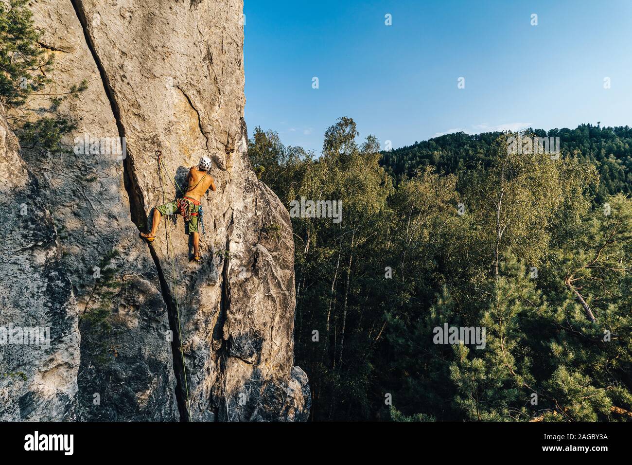 Mountain climber climbing the cliff using his climbing equipment Stock ...