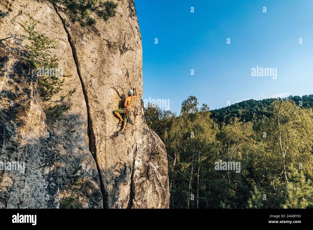Mountain climber climbing the cliff using his climbing equipment Stock ...