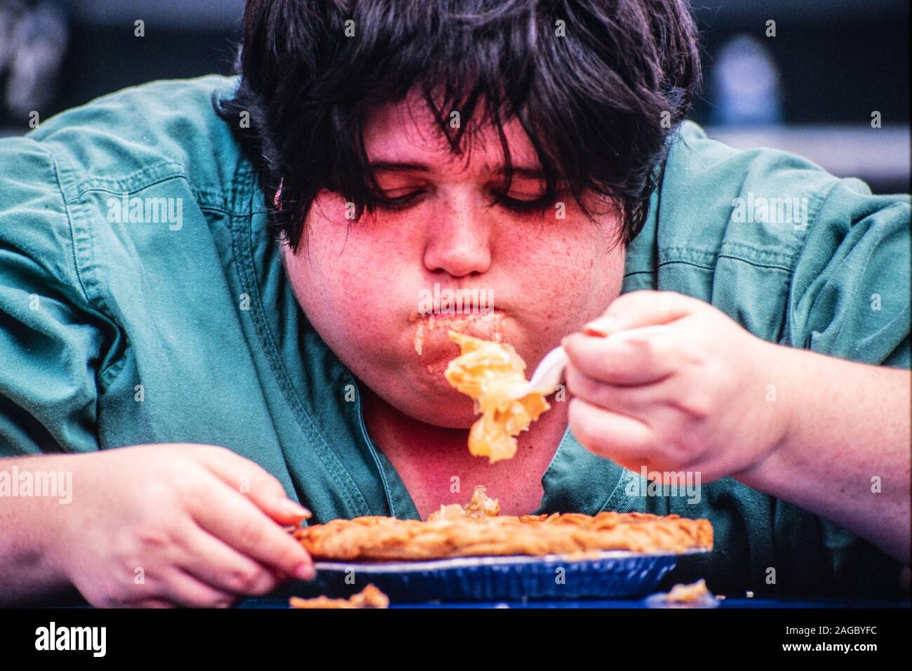 A competitor speedily devours a pie during a pie eating contest ...