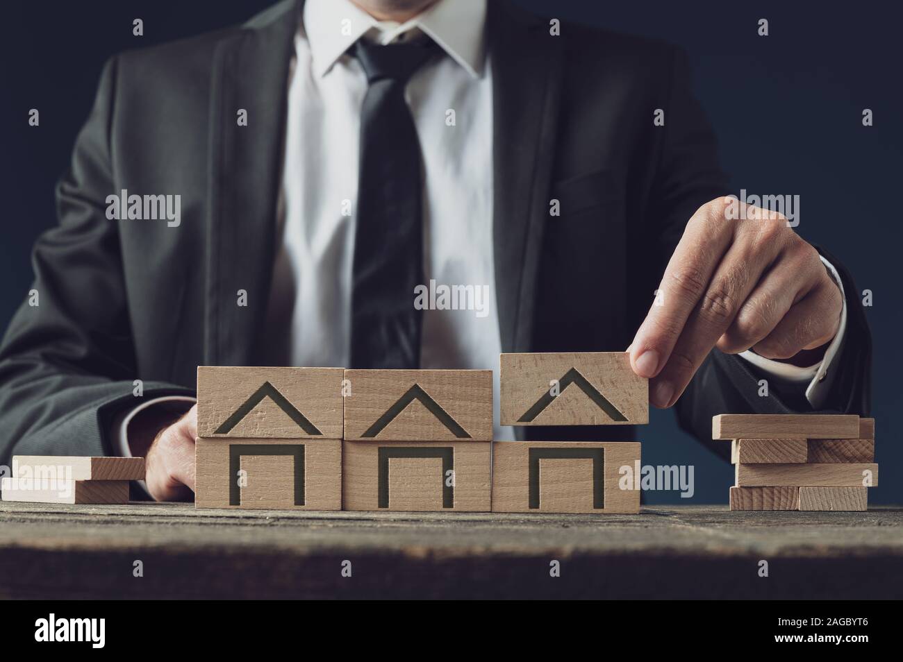 Conceptual image of real estate market - realtor building houses of ...