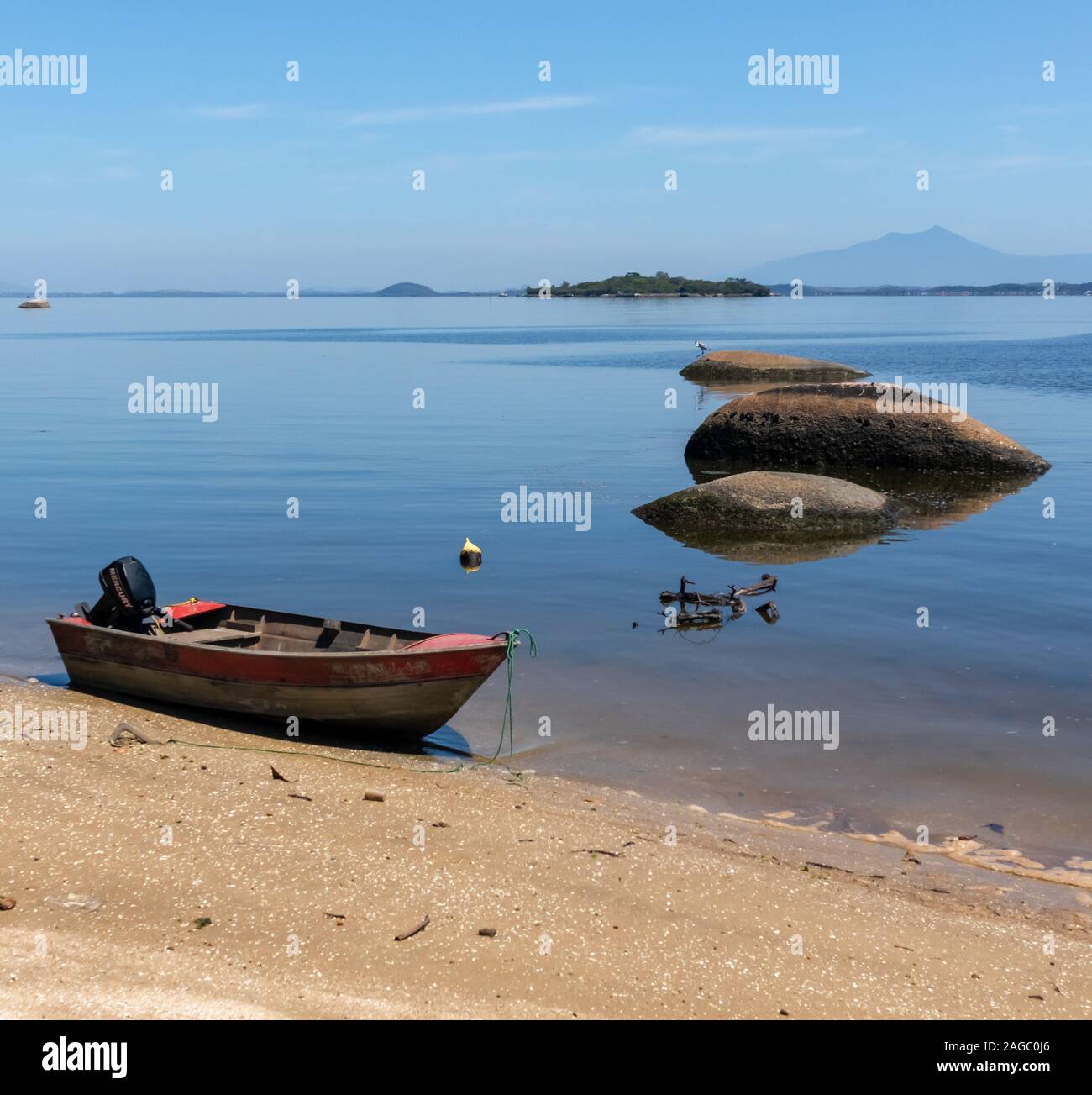 Beach, sea, rocks, fishing boat and blue sky, Paqueta Island, Rio de ...
