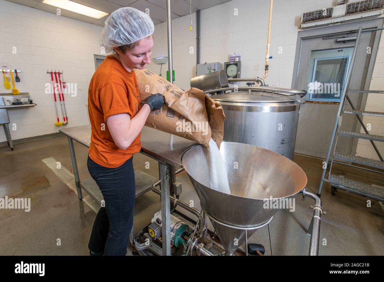 Worker pours a powder into a container to be mixed, Colora, Maryland ...