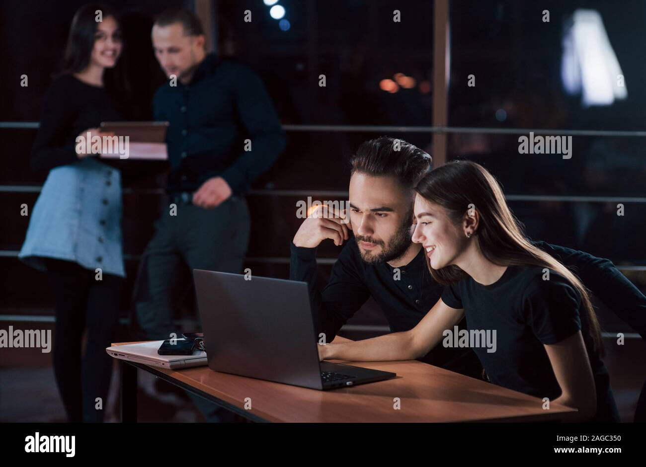 All of employees does his job. Team of young business people works on ...