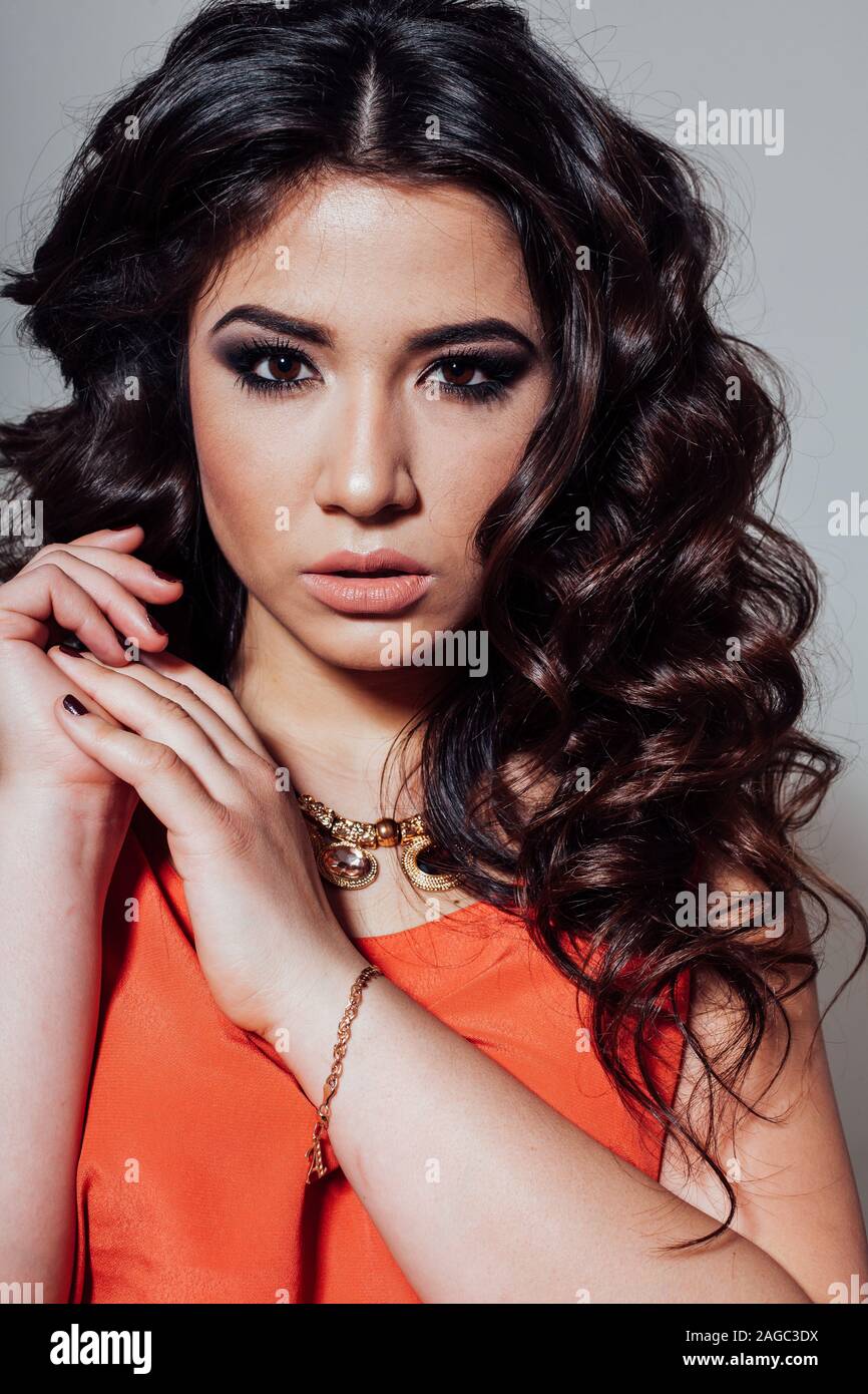 girl posing curls hairstyle business style of clothing Stock Photo - Alamy