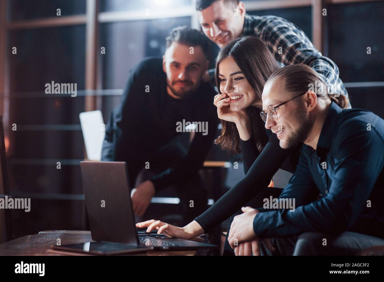 Collaboration of people. Team of young people works on their project at ...