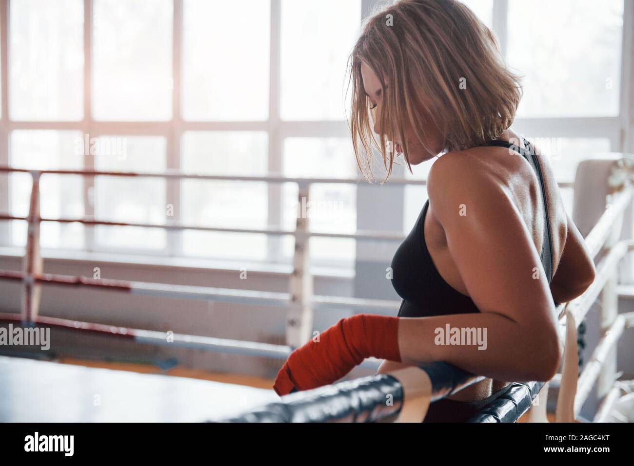 Waiting for the opponent. Tired after workout. Having rest in the gym ...