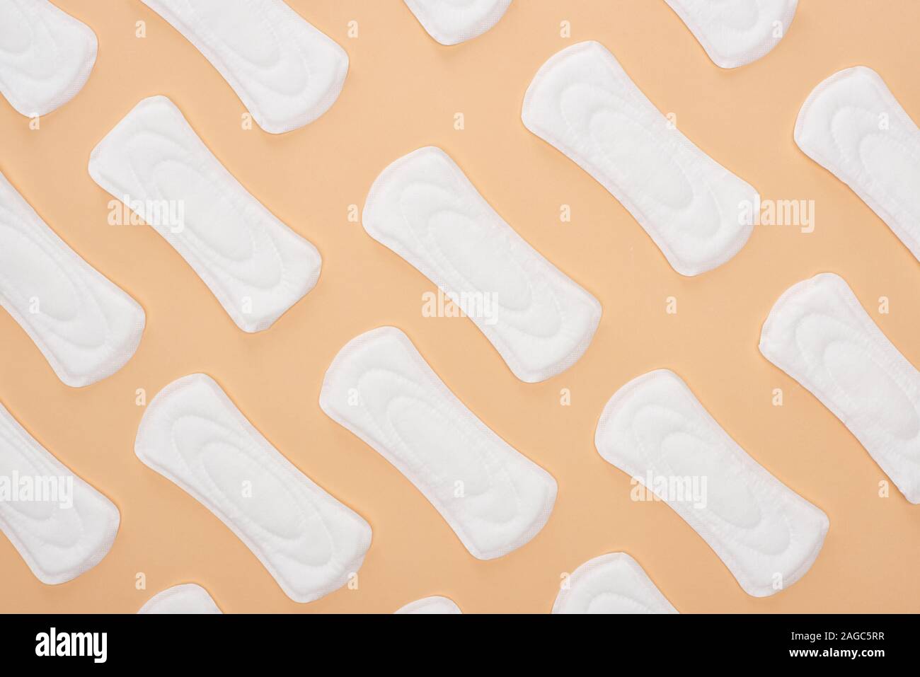 seamless pattern with white cotton sanitary towels isolated on beige ...