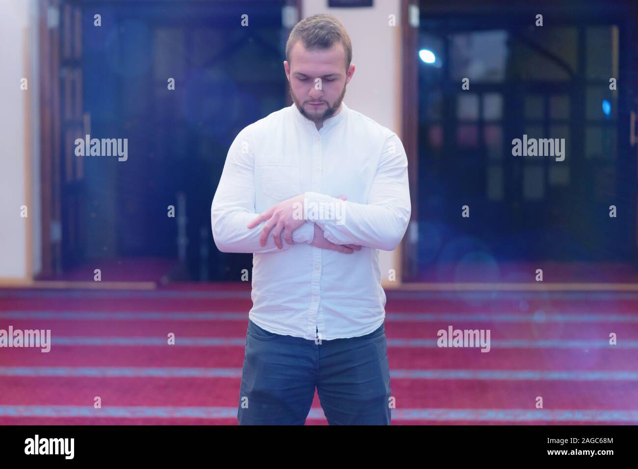 Young religious european muslim man praying inside the beautiful big ...