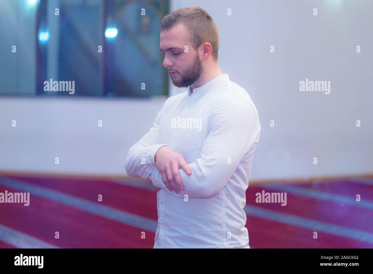 Young religious european muslim man praying inside the beautiful big ...