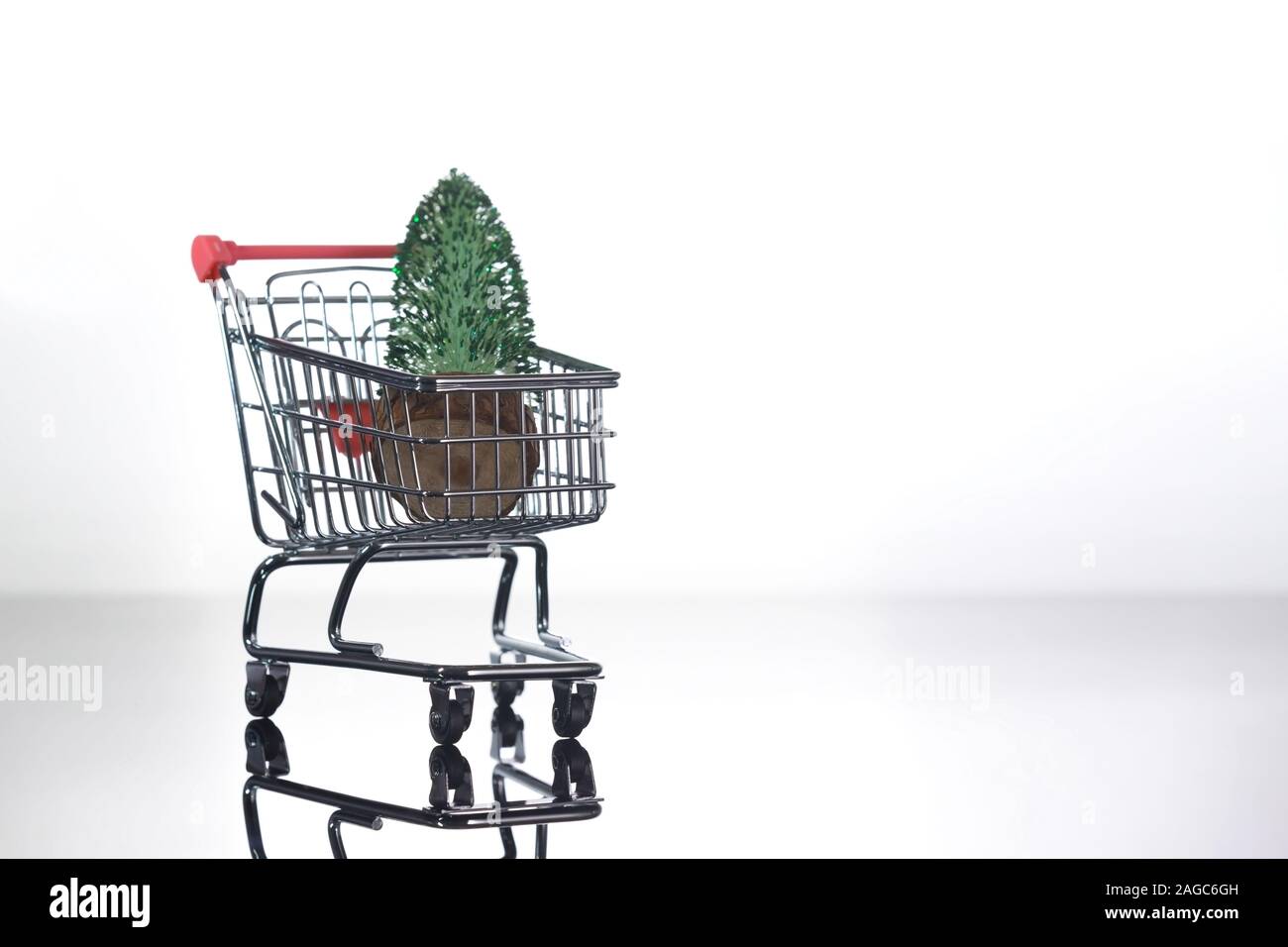 Mini Christmas Tree Inside Tiny Shopping Trolley on Light Background ...