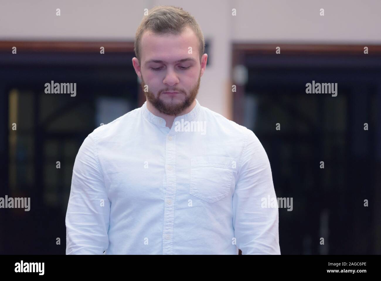Young religious european muslim man praying inside the beautiful big ...