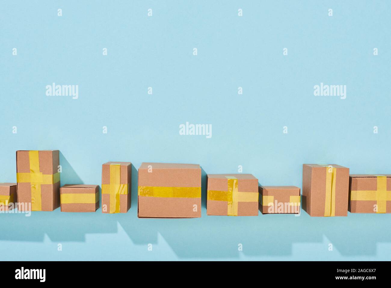 top view of closed cardboard boxes with shadow on blue background Stock ...