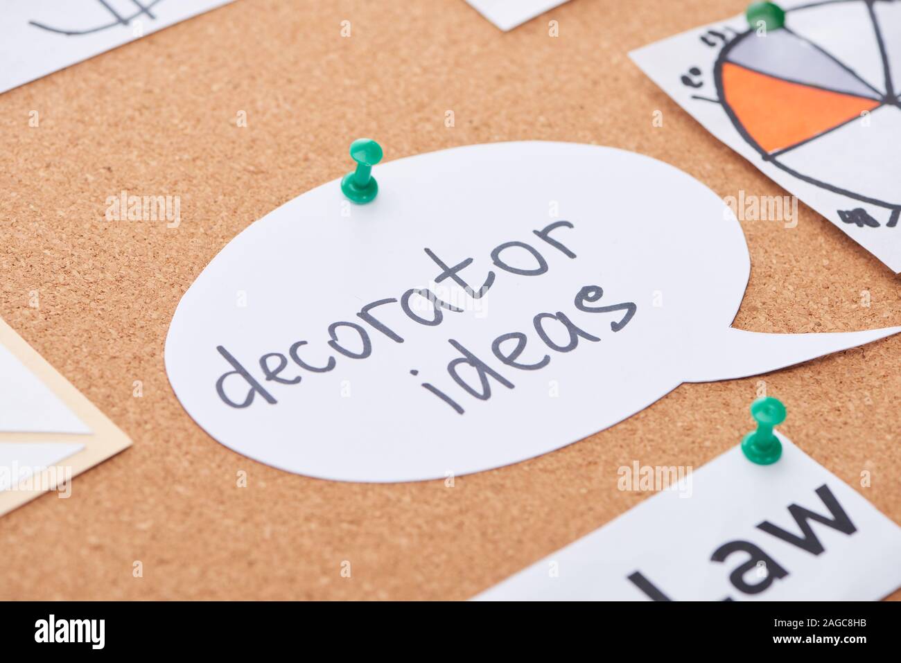 paper card with decorator ideas lettering pinned on cork office board ...