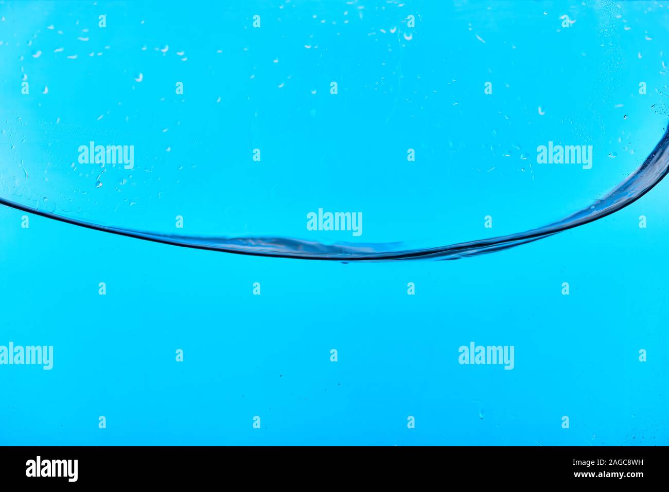 clear fresh water on blue background with drops Stock Photo - Alamy