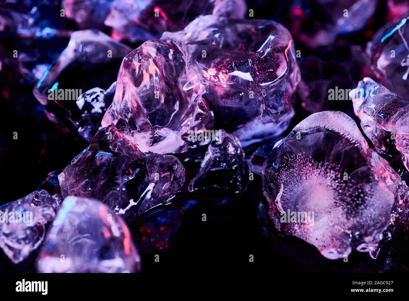 frozen ice cubes with purple lighting isolated on black Stock Photo - Alamy
