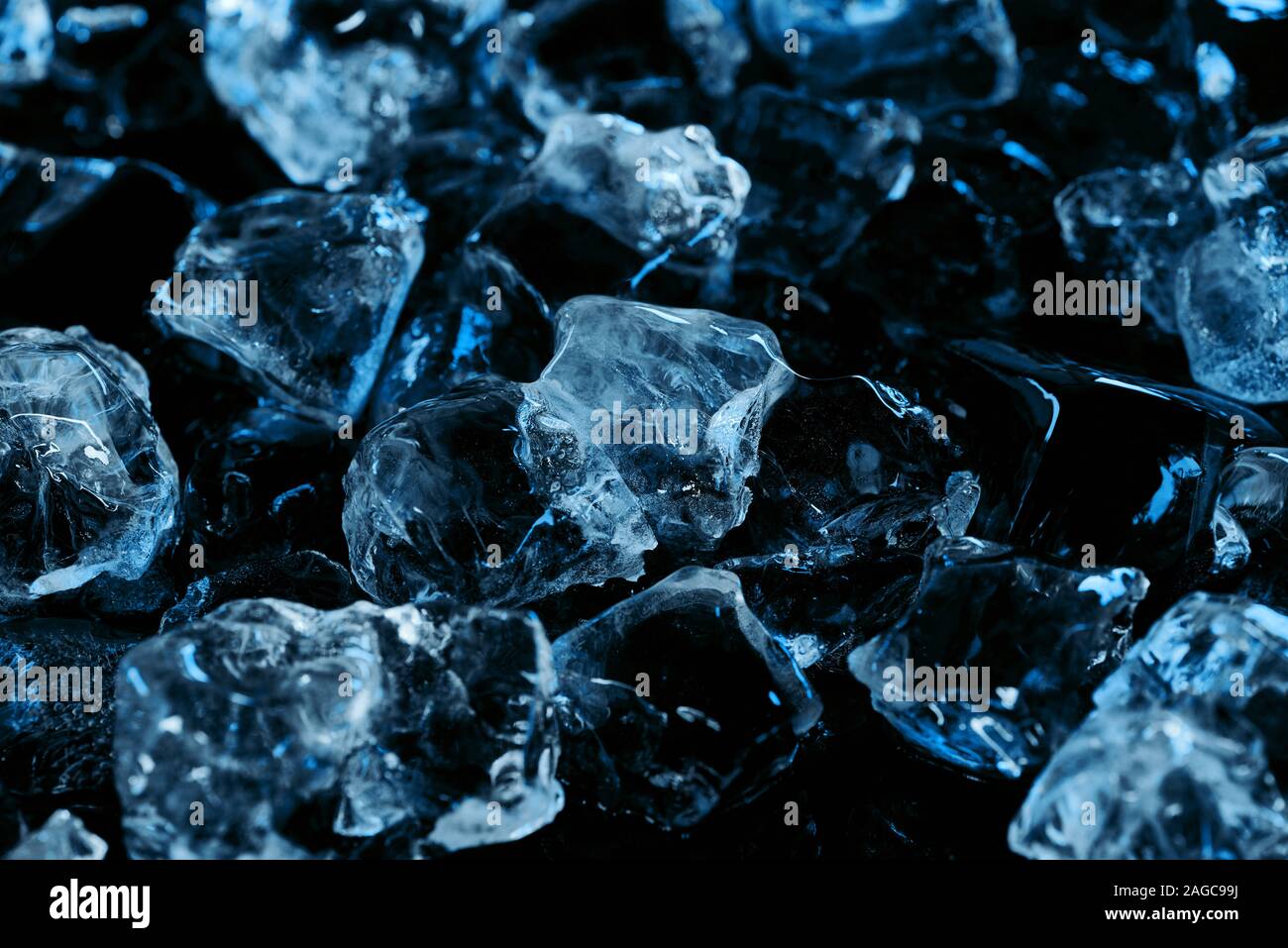 frozen clear ice cubes with blue lighting isolated on black Stock Photo ...
