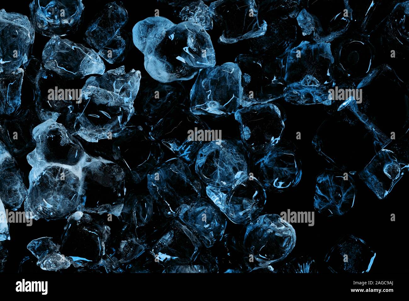 top view of frozen transparent ice cubes with blue lighting isolated on ...