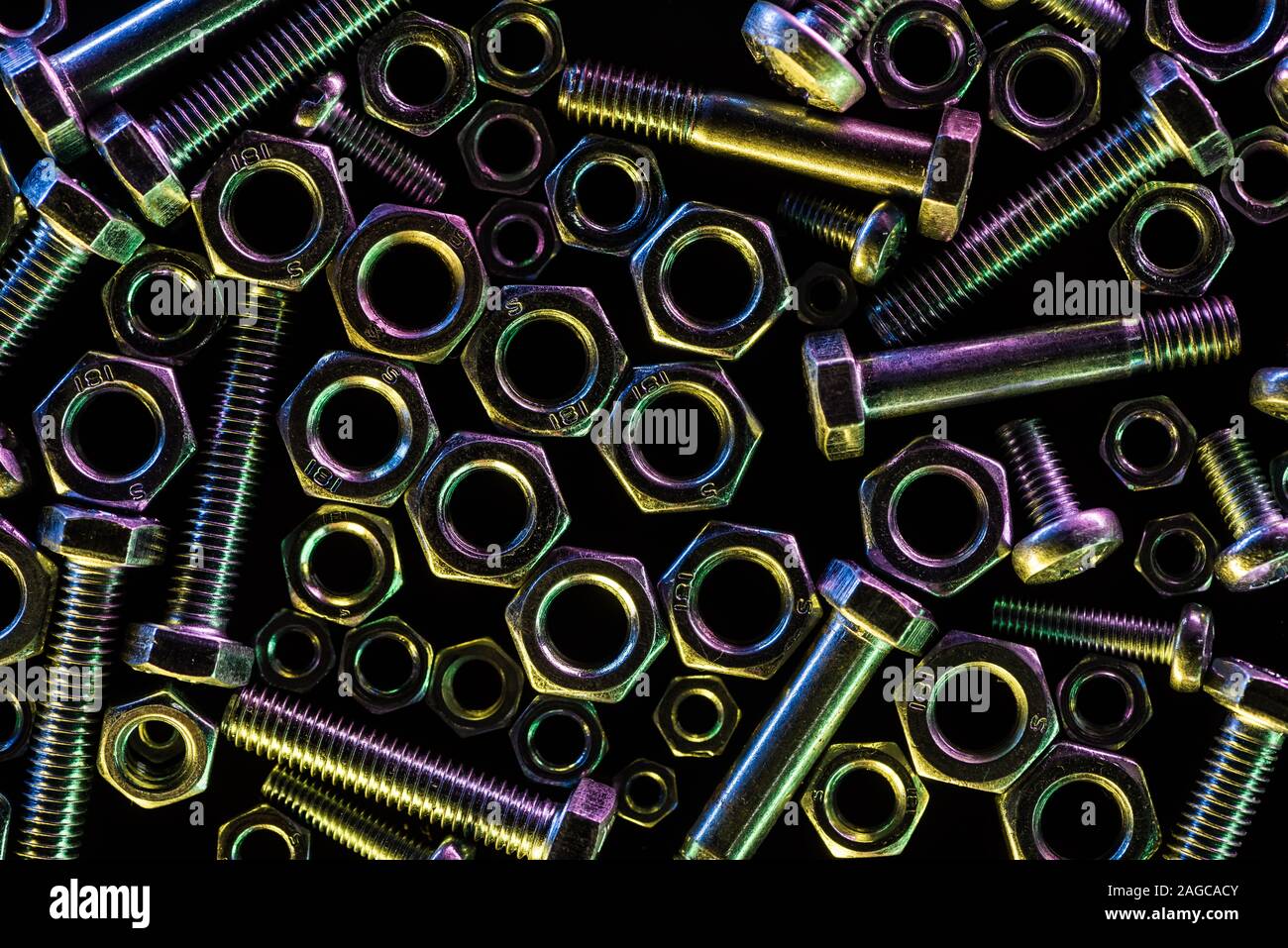 top view of scattered steel bolts and nuts isolated on black Stock ...