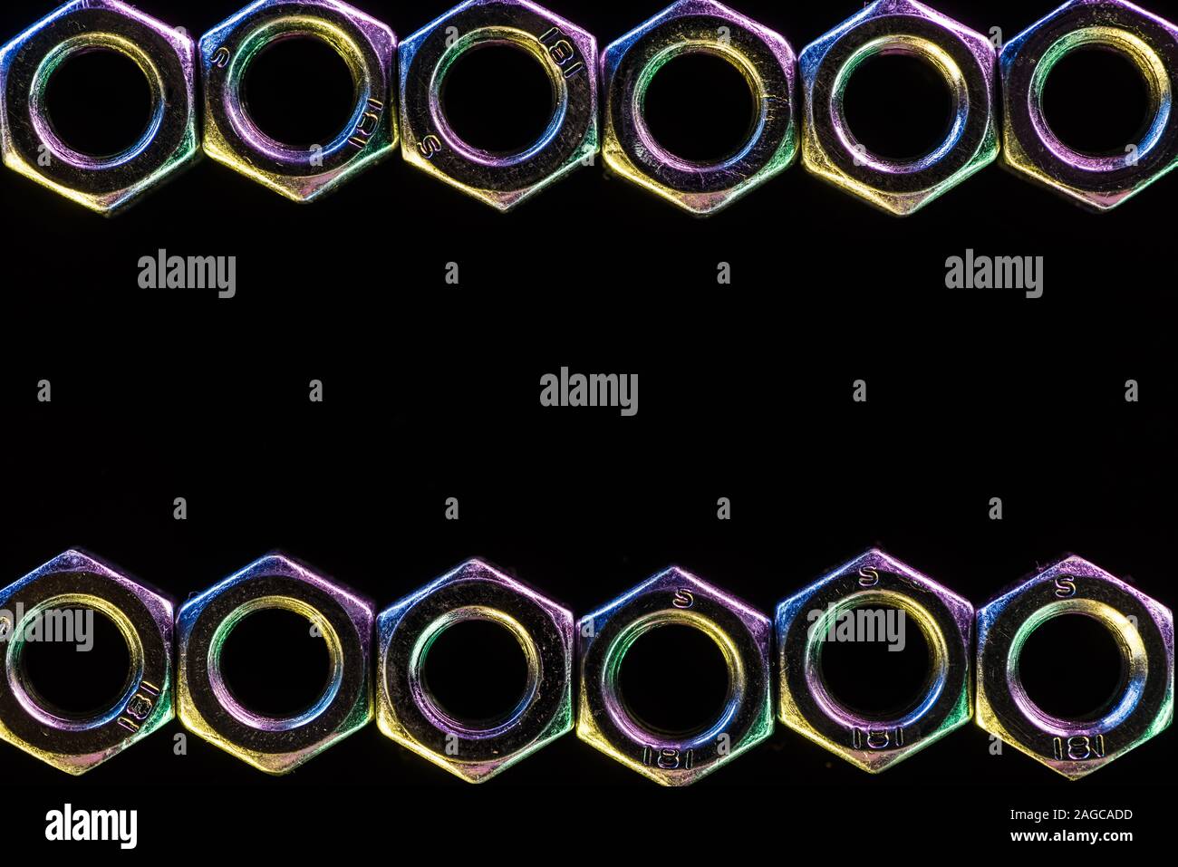 close up view of shiny metal nuts rows isolated on black Stock Photo ...
