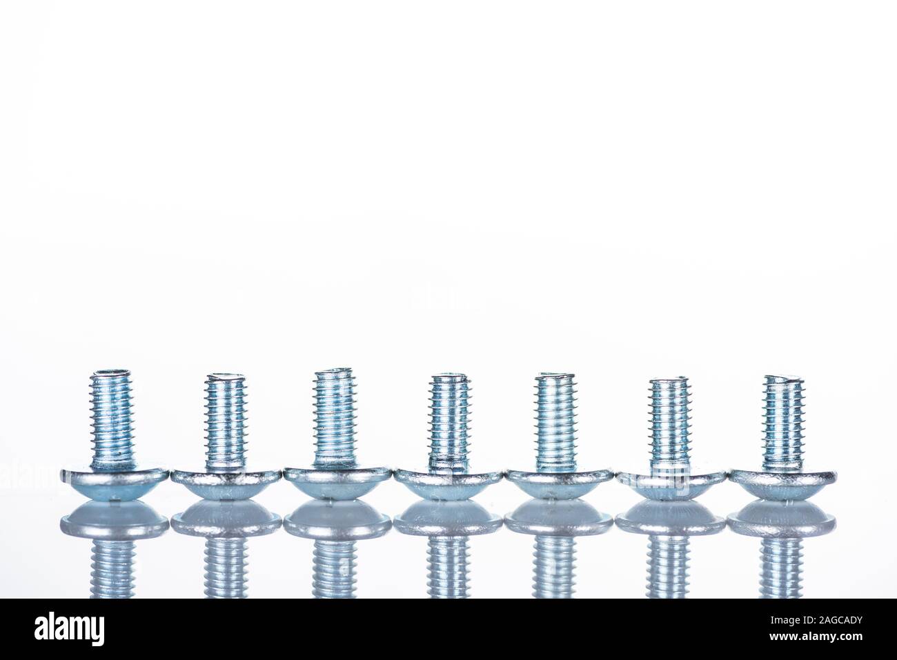 close up view of shiny short bolts isolated on white with copy space ...