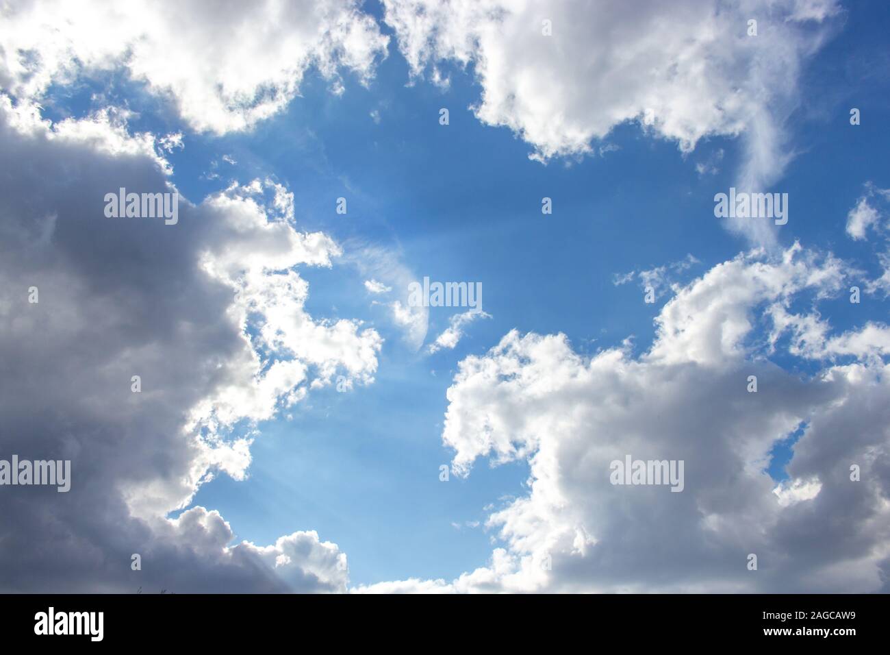 Beautiful blue sky with white clouds of an unusual shape. Clear summer ...