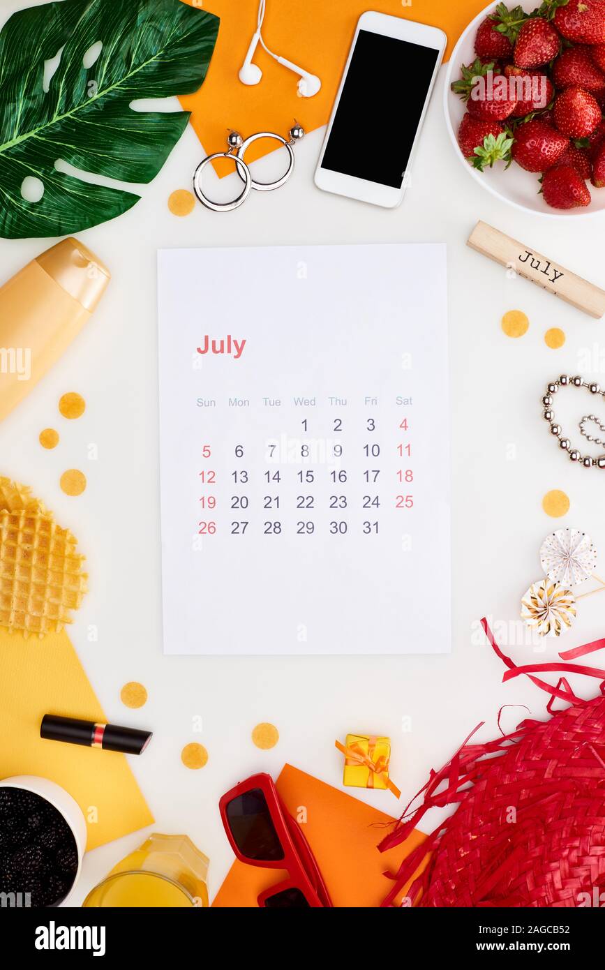 july calendar page, wooden block with july inscription, fresh ...