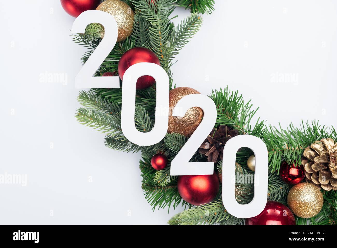 top view of 2020 numbers on Christmas tree wreath on white background ...