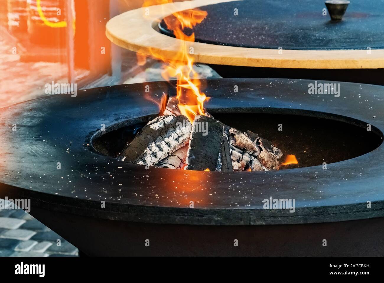 Outdoor wood-burning grill for frying steaks and pork ribs over an open ...