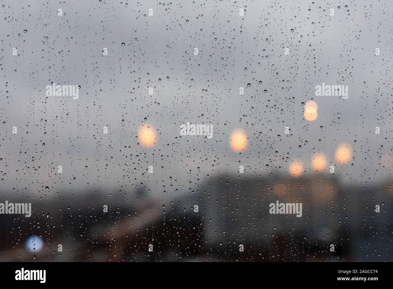 Raindrops downpour on the window, defocus lantern house bad weather ...
