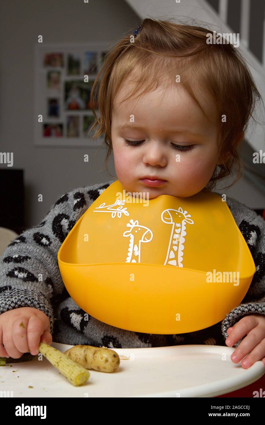 Toddler girl eating first foods UK Stock Photo - Alamy