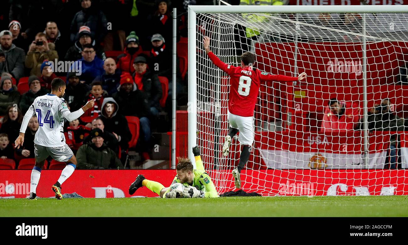 Manchester United's Juan Mata jumps over Colchester United's goalkeeper ...