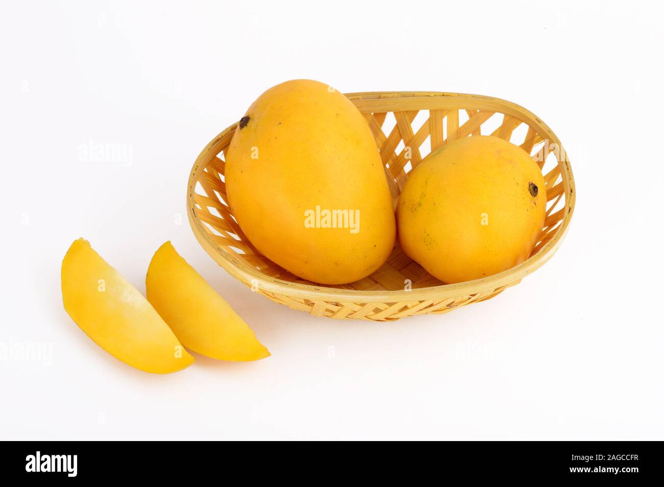 Mango fruit in basket with slice on white background Stock Photo - Alamy
