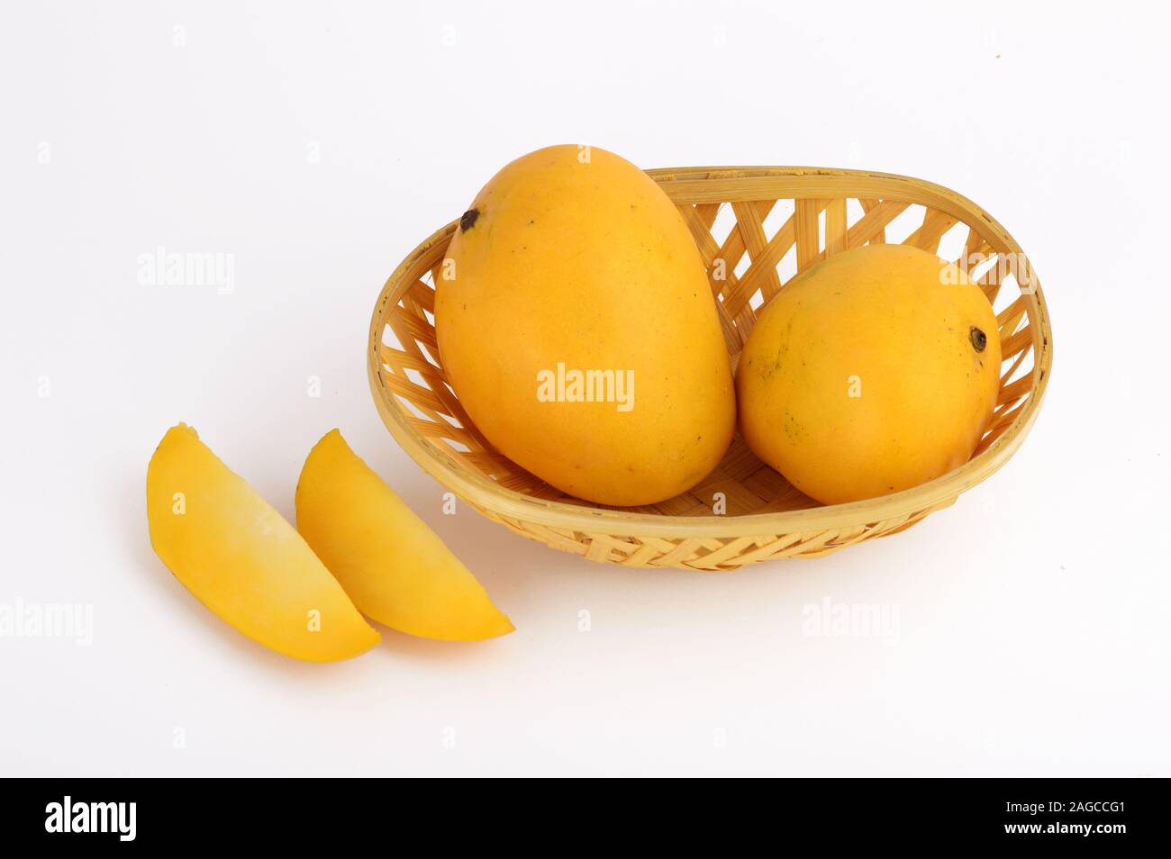 Mango fruit in basket with slice on white background Stock Photo - Alamy