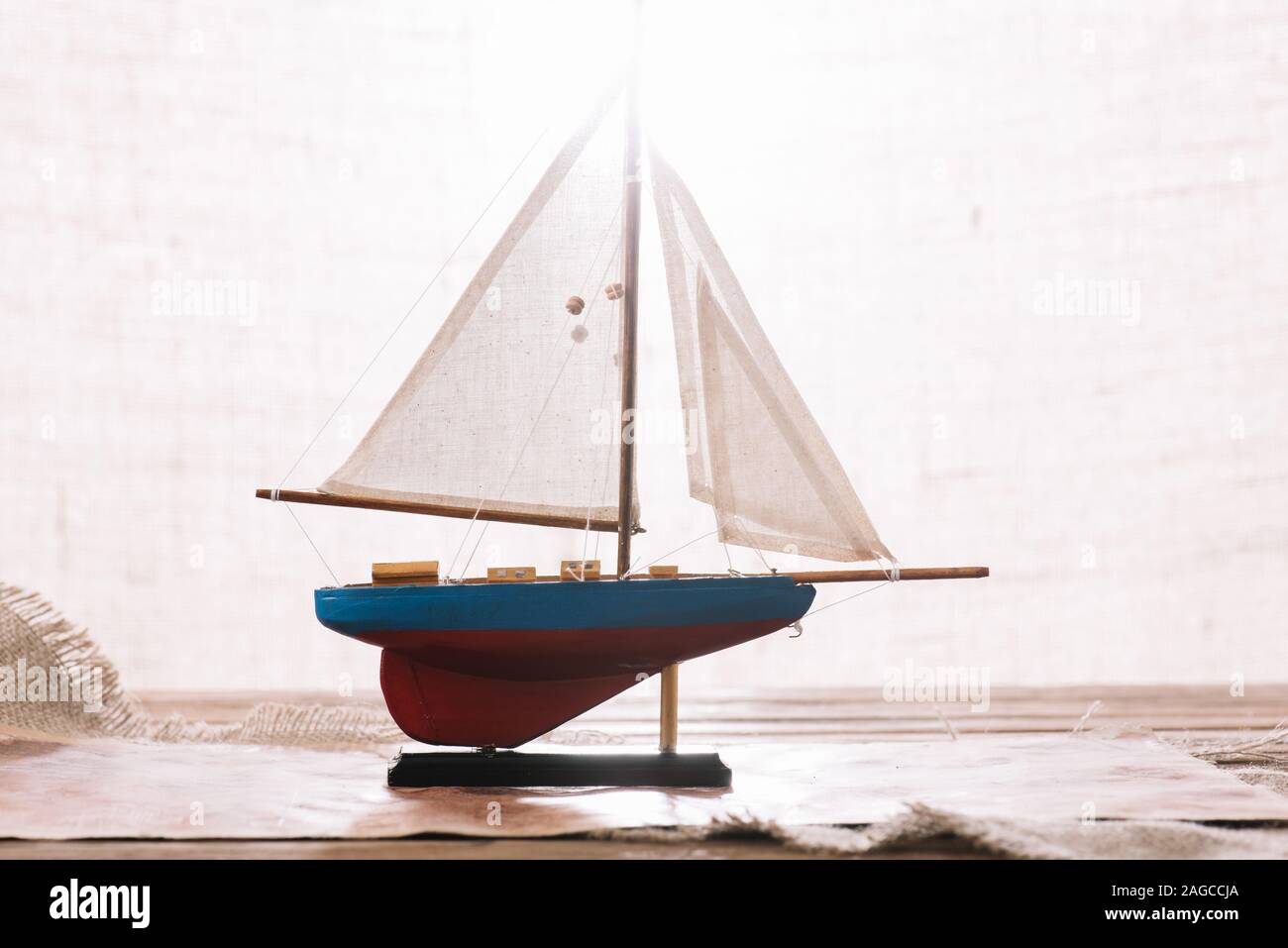 decorative ship with white sail on surface with hessian Stock Photo - Alamy