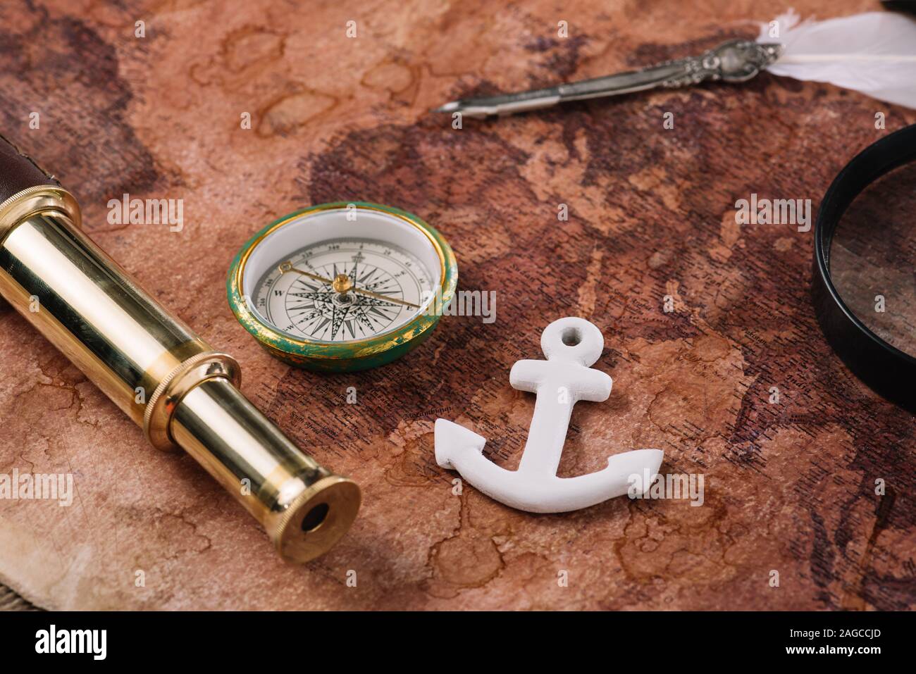 compass, white anchor, nib and telescope on world map Stock Photo - Alamy
