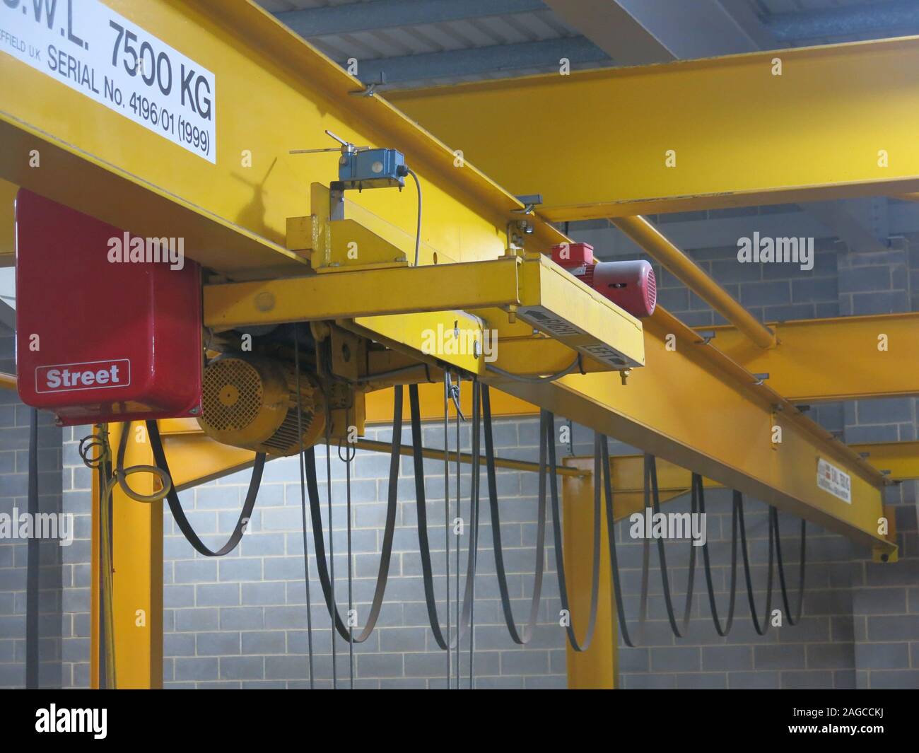 Example of a solid yellow Street Cranexpress hoist on display in the ...