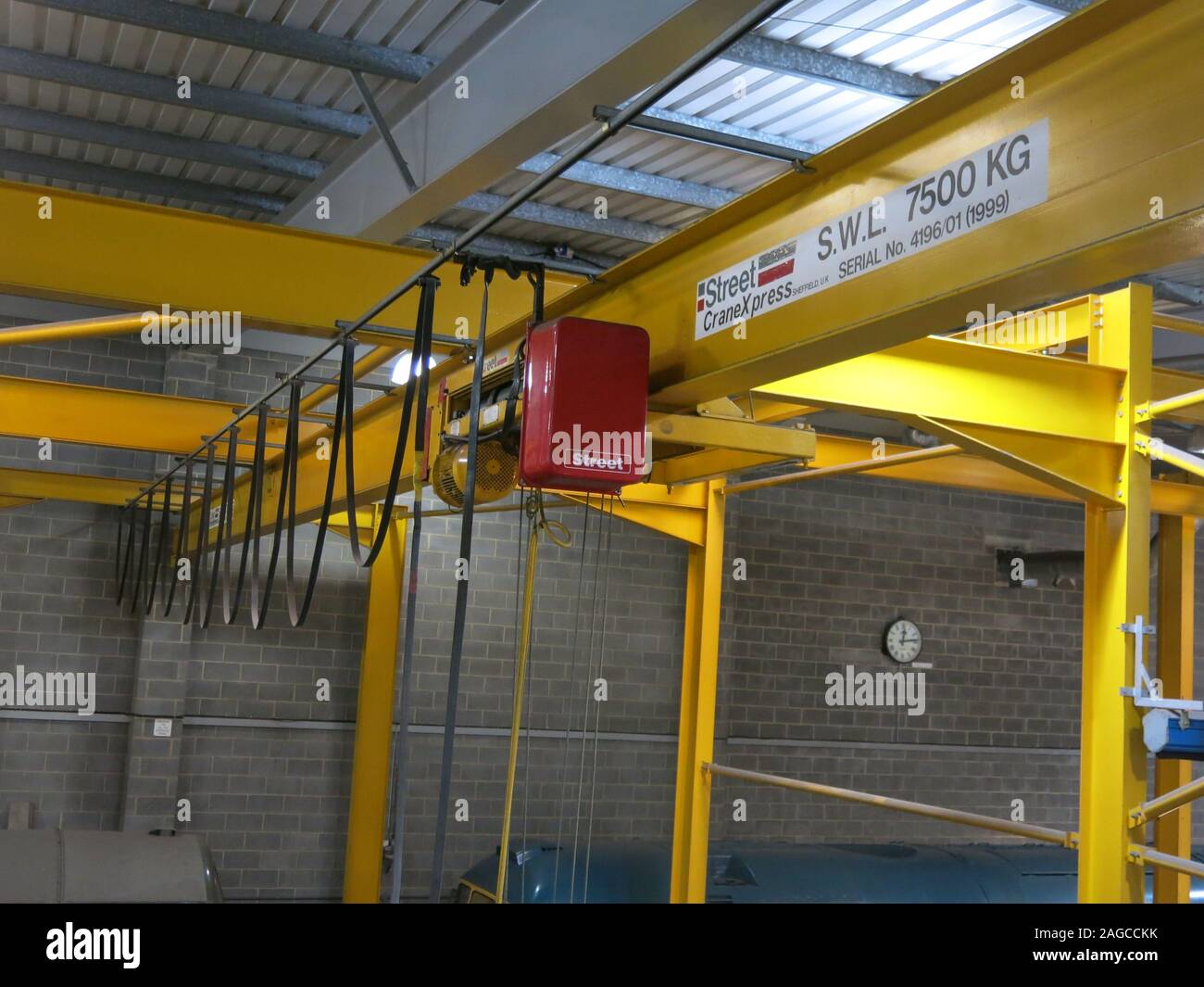 Example of a solid yellow Street Cranexpress hoist on display in the ...