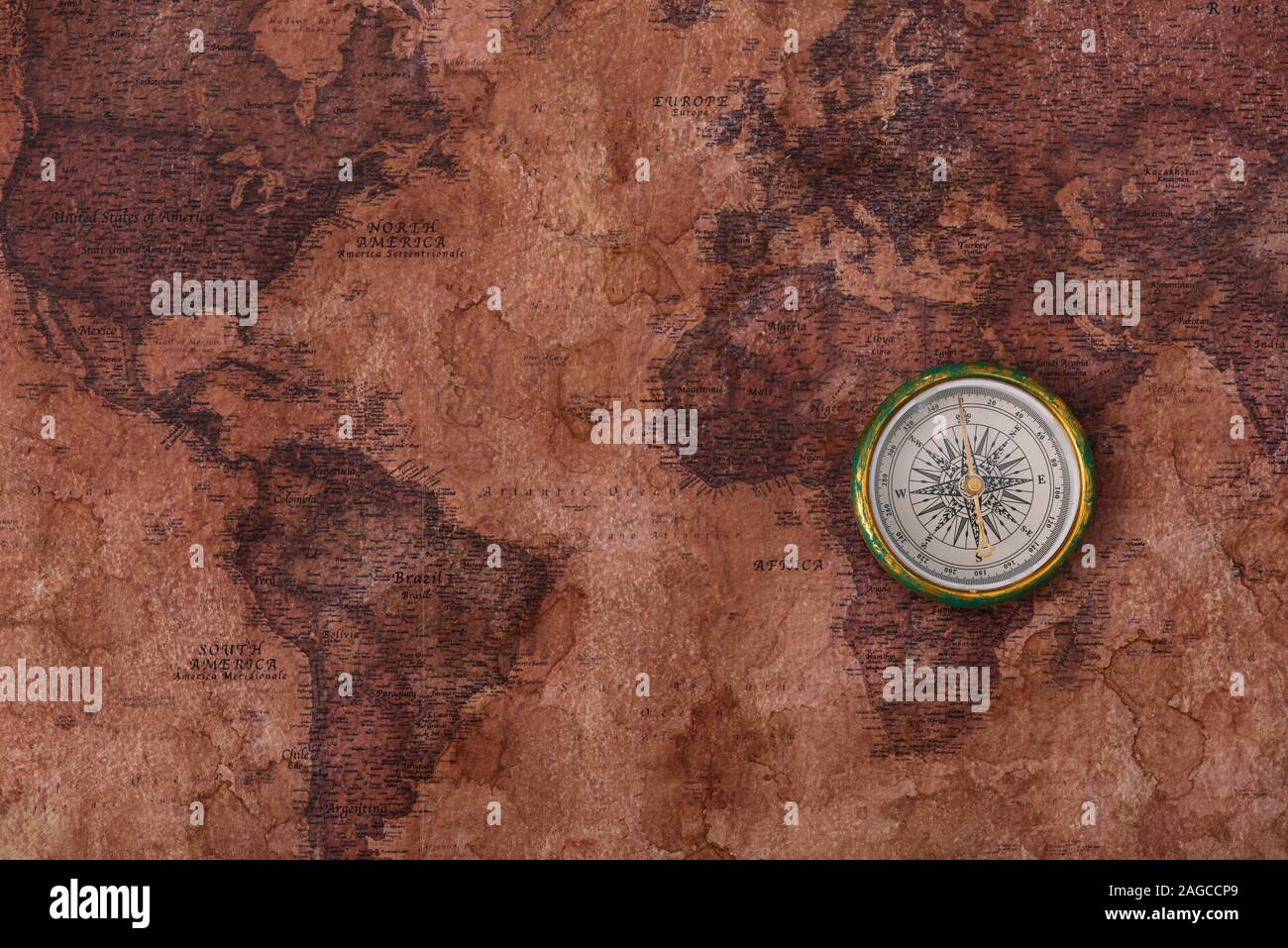 top view of compass on old world map Stock Photo - Alamy