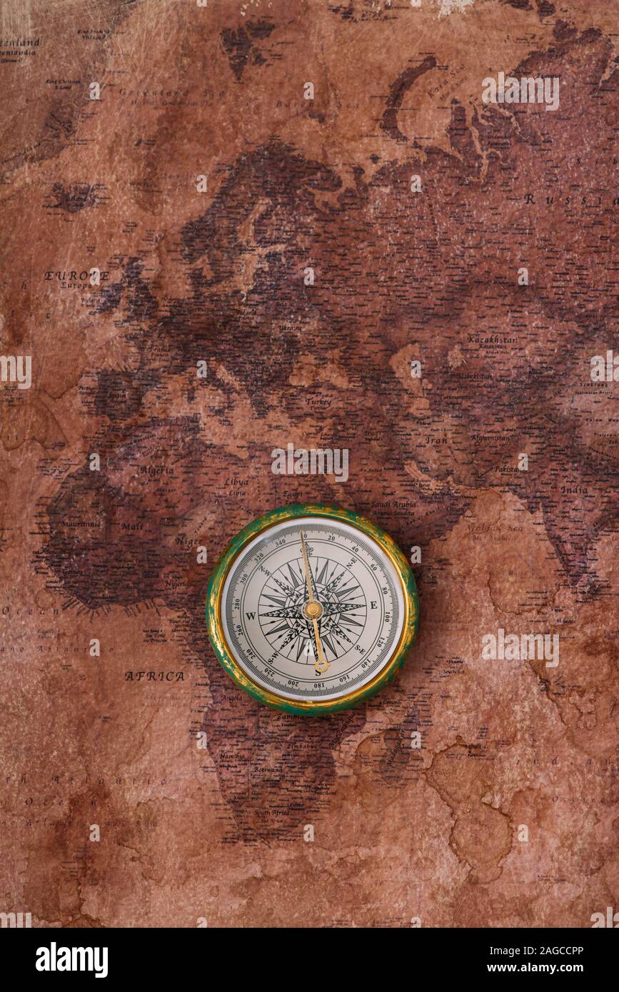 top view of compass on ancient world map Stock Photo - Alamy