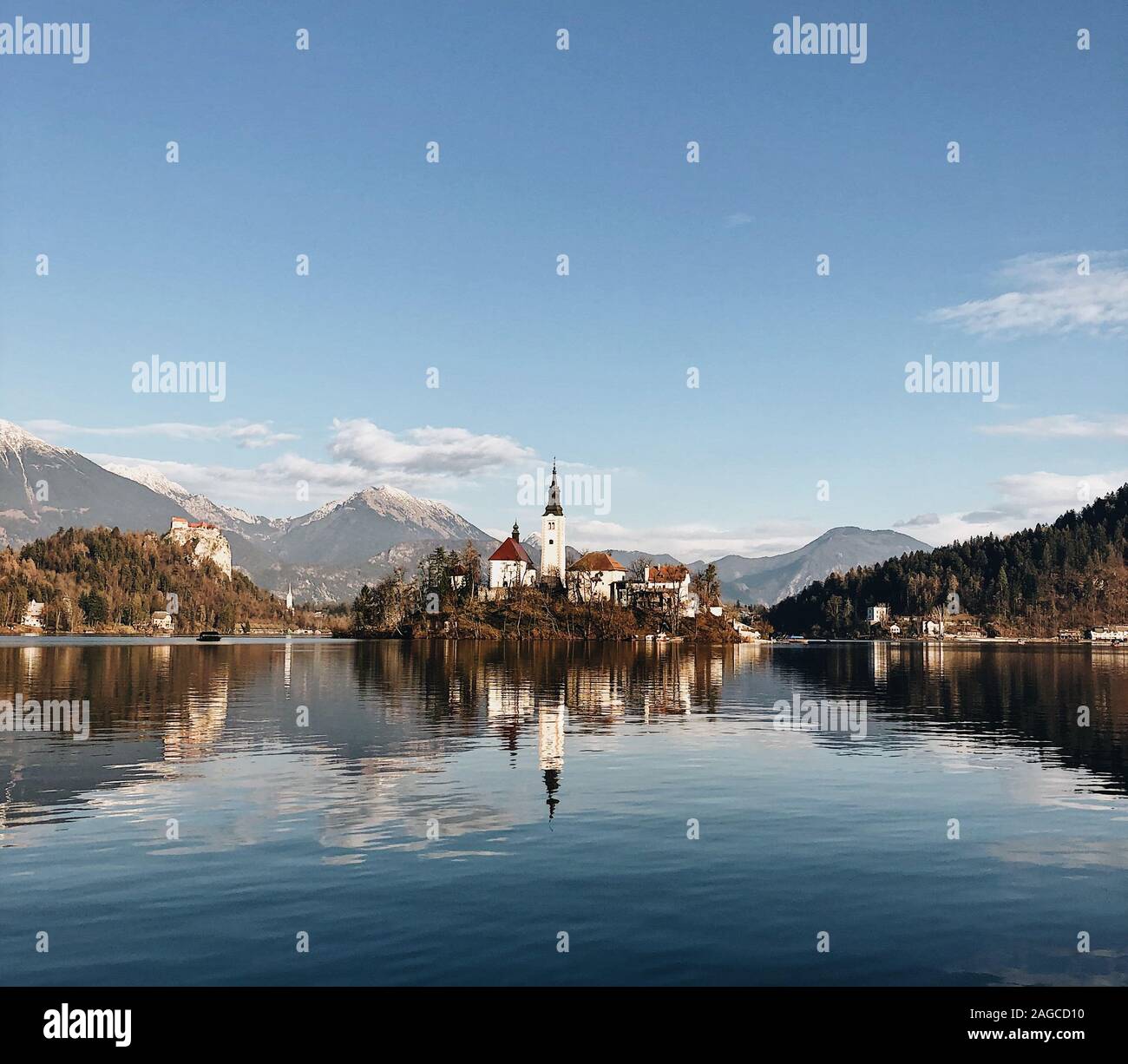 Ancient castle surrounded by a mountainous scenery reflecting in the ...