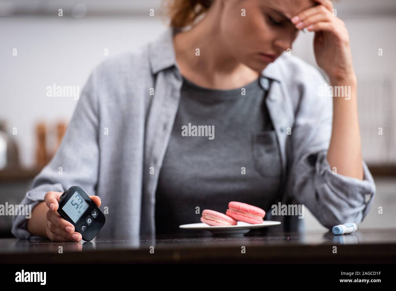 selective focus of upset woman with sweet allergy sitting near dessert ...