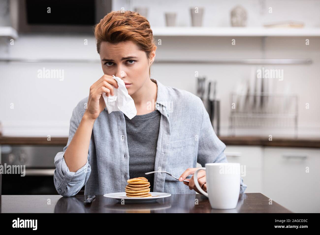 sick woman sneezing in tissue near pancakes at home Stock Photo - Alamy