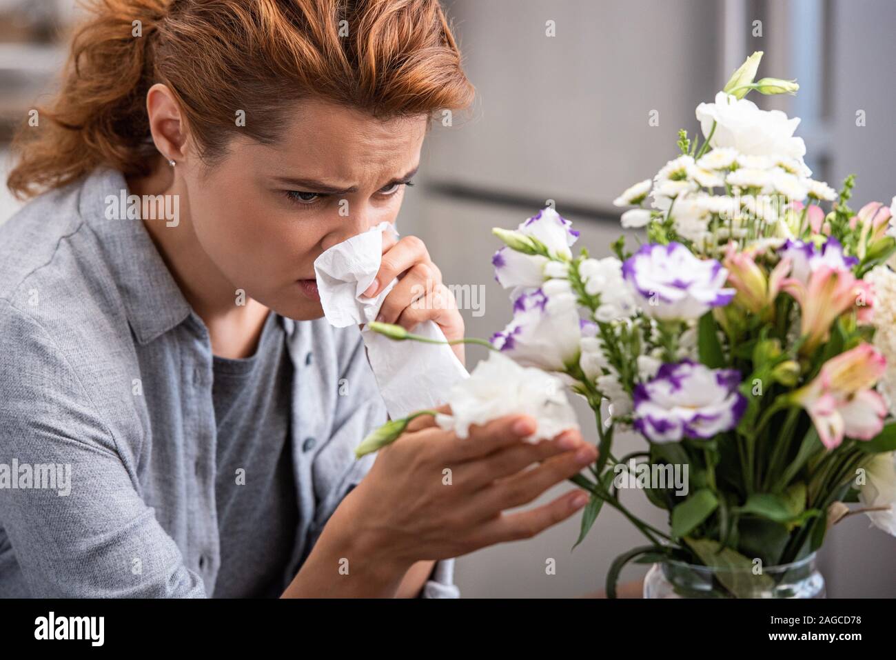 selective focus of woman with pollen allergy holding tissue and ...
