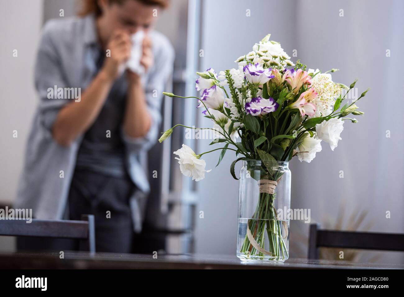 Woman sneezing tissue in blooming hi-res stock photography and images ...